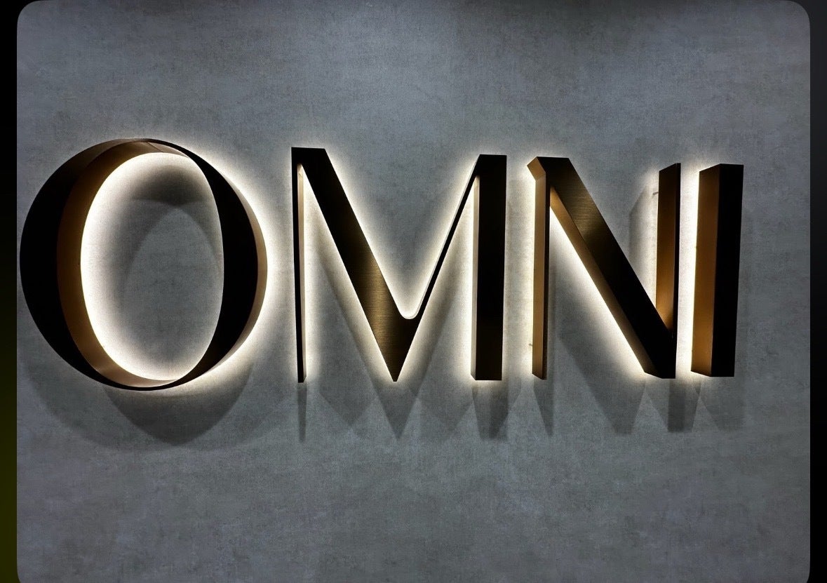 Halo-Lit Satin Gold Stainless Steel Letters Installed for OMNI Dental | Custom Interior Signage