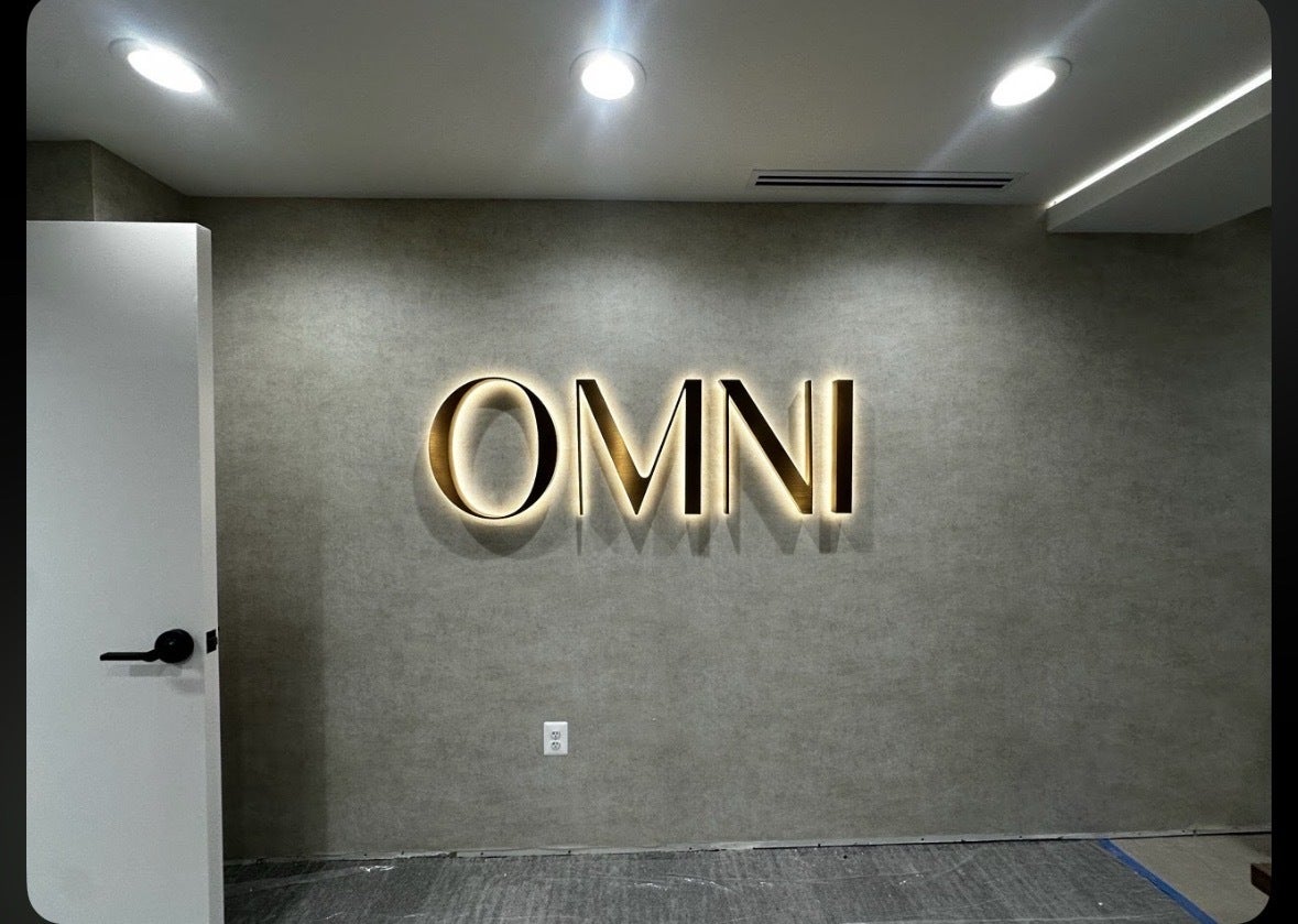 Halo-Lit Satin Gold Stainless Steel Letters Installed for OMNI Dental | Custom Interior Signage